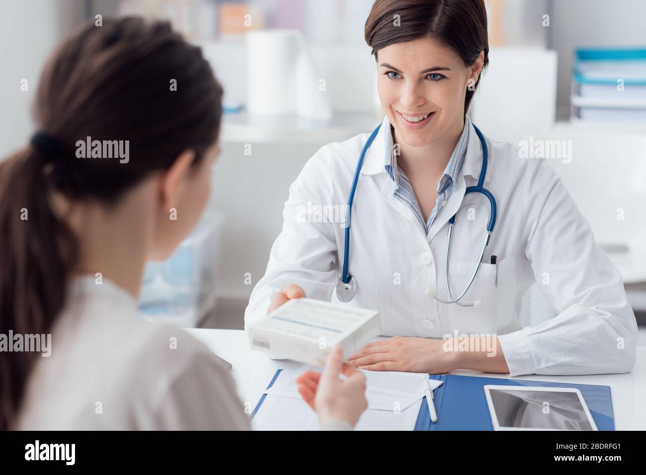 Female doctor giving a prescription medicine to the patient, healthcare ...