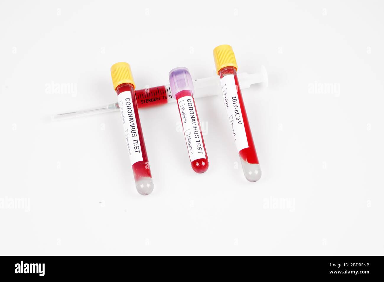 Syringe and filled blood tubes on white background Stock Photo - Alamy