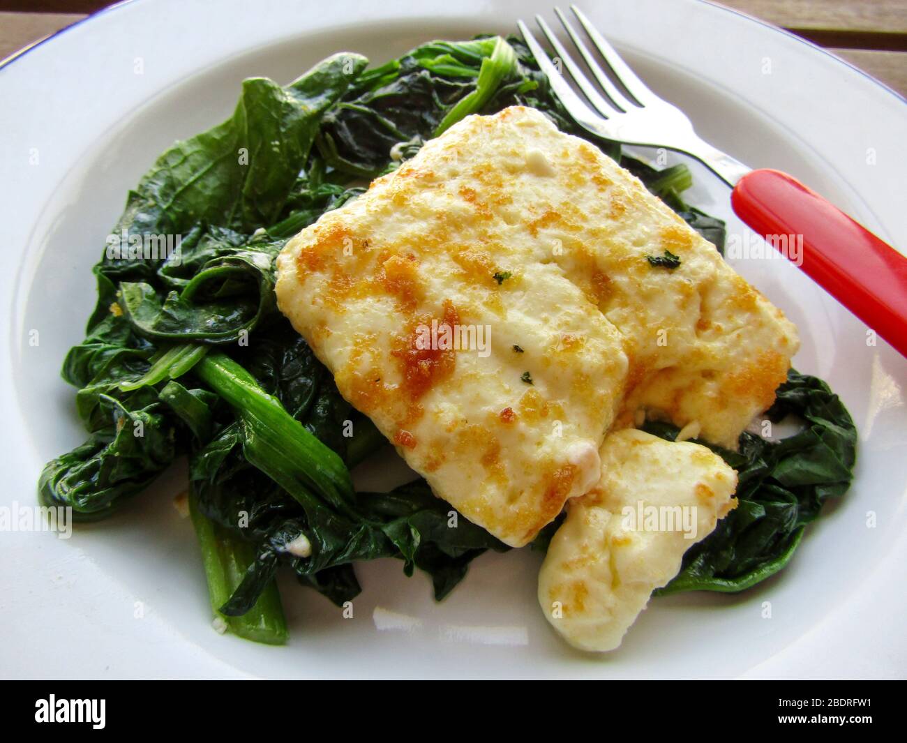 Greek Cuisine. Fried Feta Saganaki with Spinach, Crete, Greece Stock ...