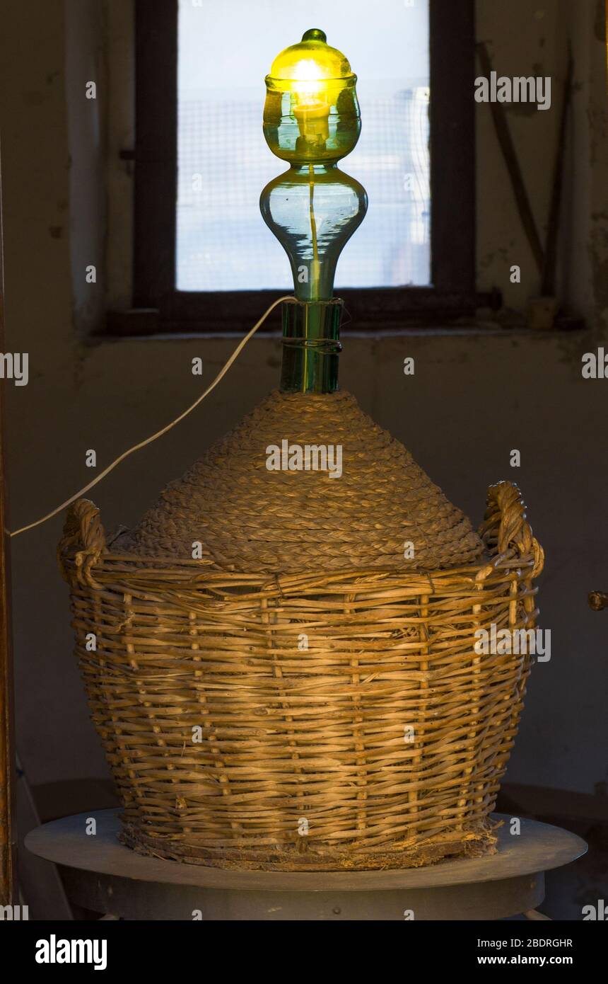 Empty demijohn with a light bulb turned on Stock Photo - Alamy