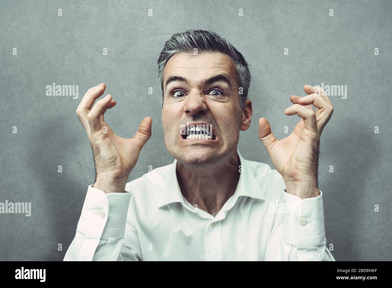 Angry furious man screaming at camera and raising his hands, anger and ...