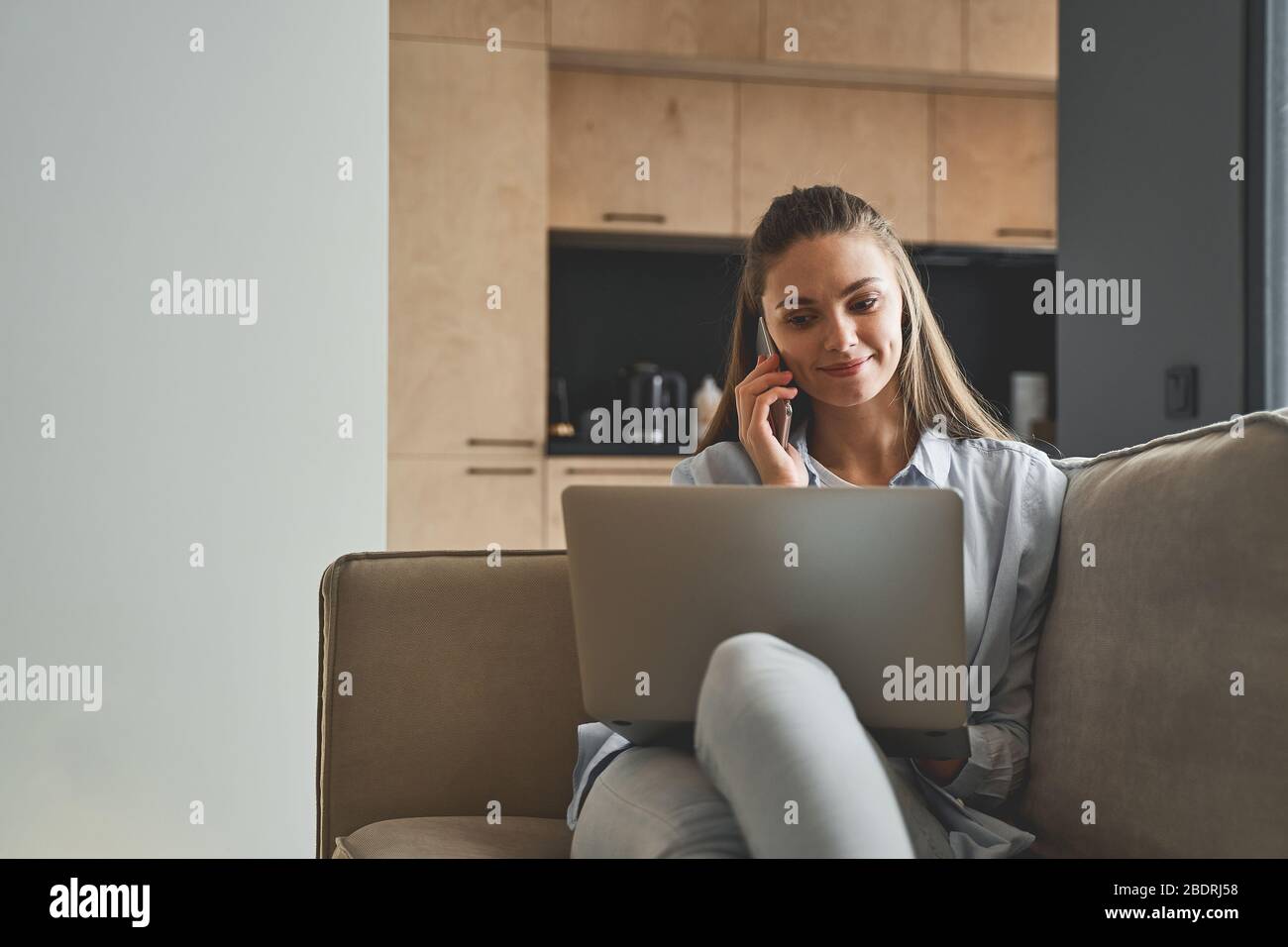 Girl with a computer calling on the smartphone Stock Photo - Alamy