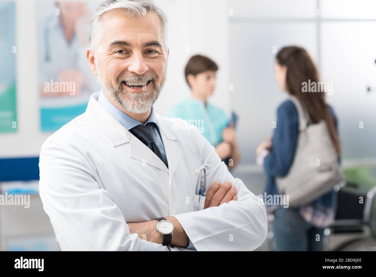 A doctor poses for a portrait and smiles at the camera Stock Photo - Alamy