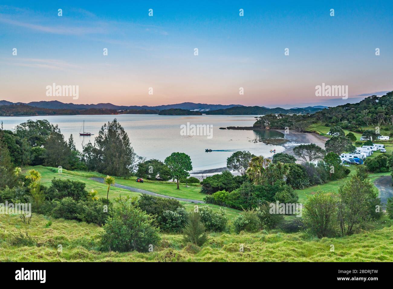 Campground at Puriri Bay, Whangaruru Harbour at dawn, near village of ...