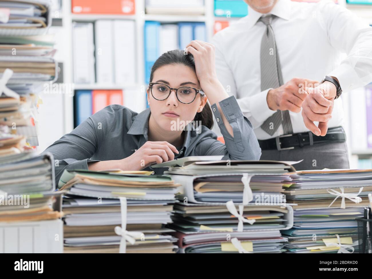 Demanding boss pointing to his watch and asking to his employee to ...