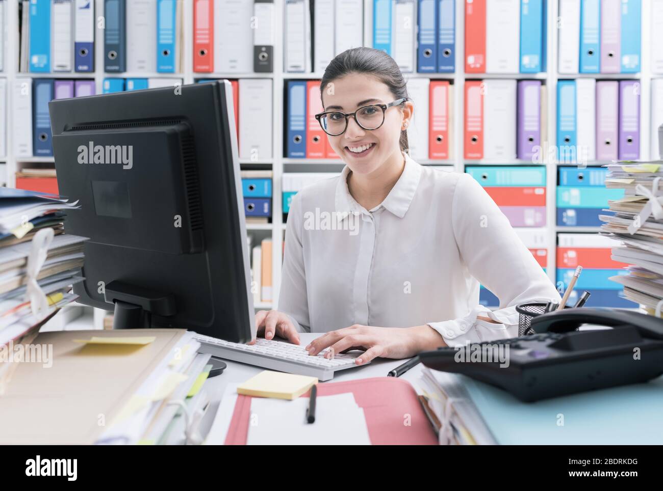 Secretary typing paperwork hi-res stock photography and images - Alamy