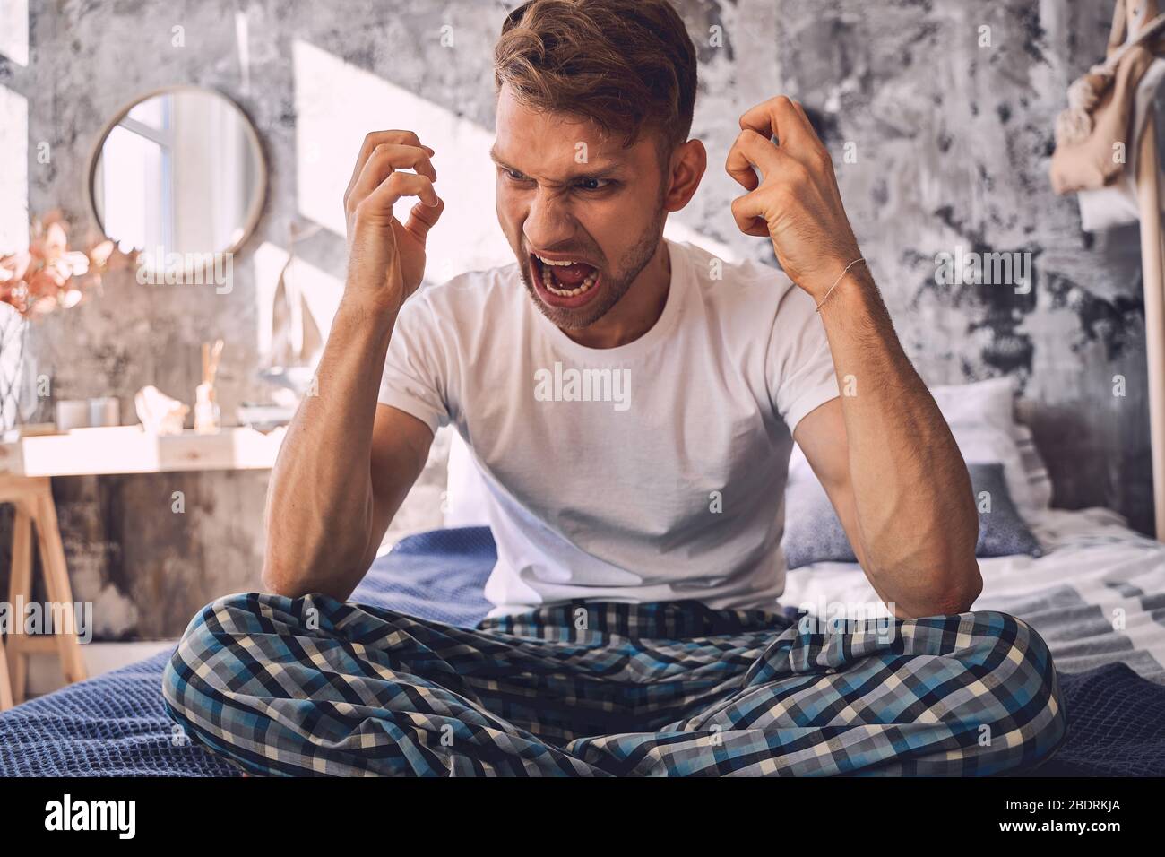 Irritated young male person shouting at home Stock Photo - Alamy