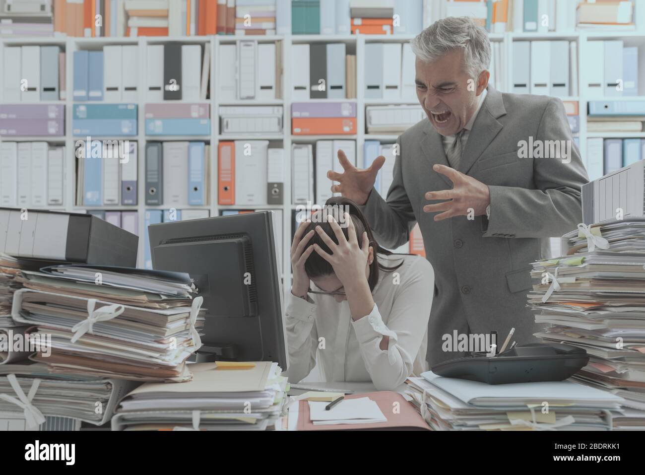 Angry boss yelling at his young employee, she is stressed and feeling ...