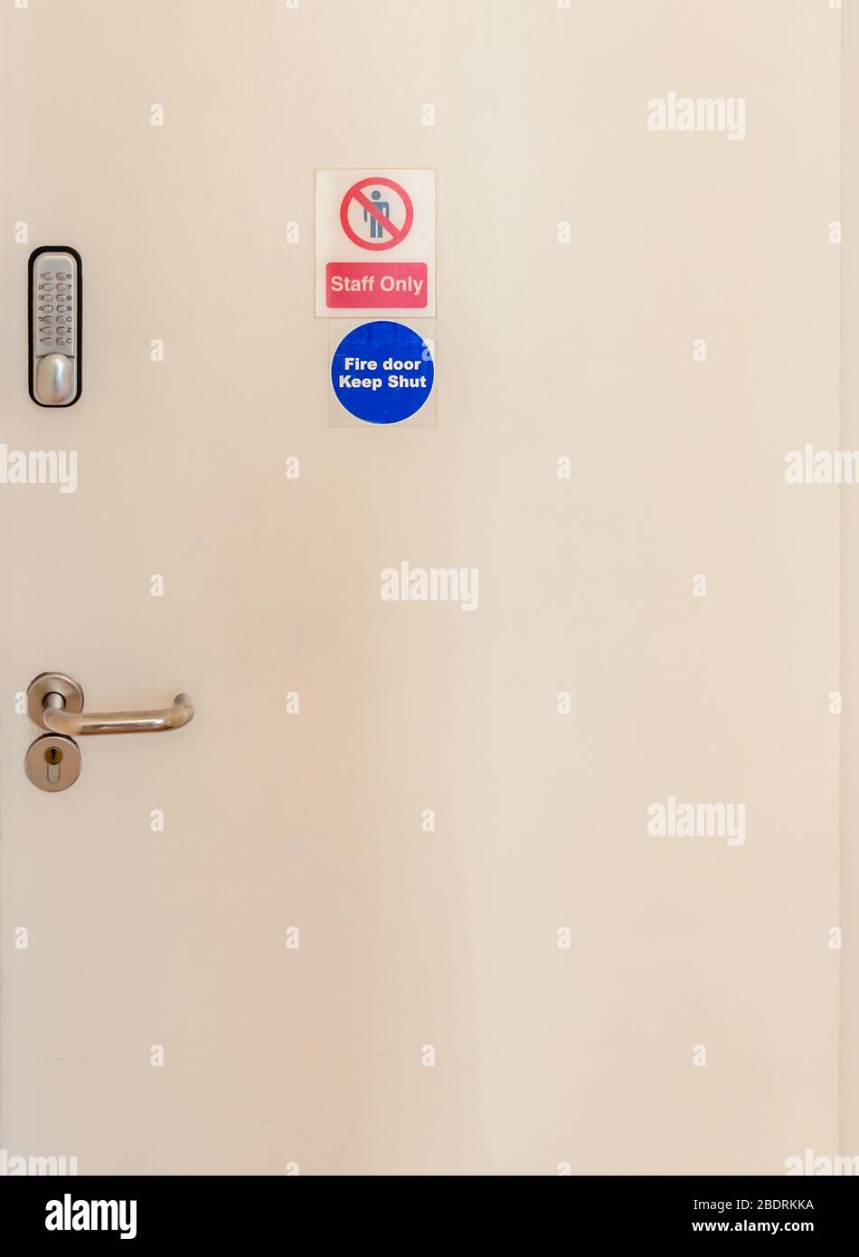 Staff only door sign outside workplace with security door lock keypad ...