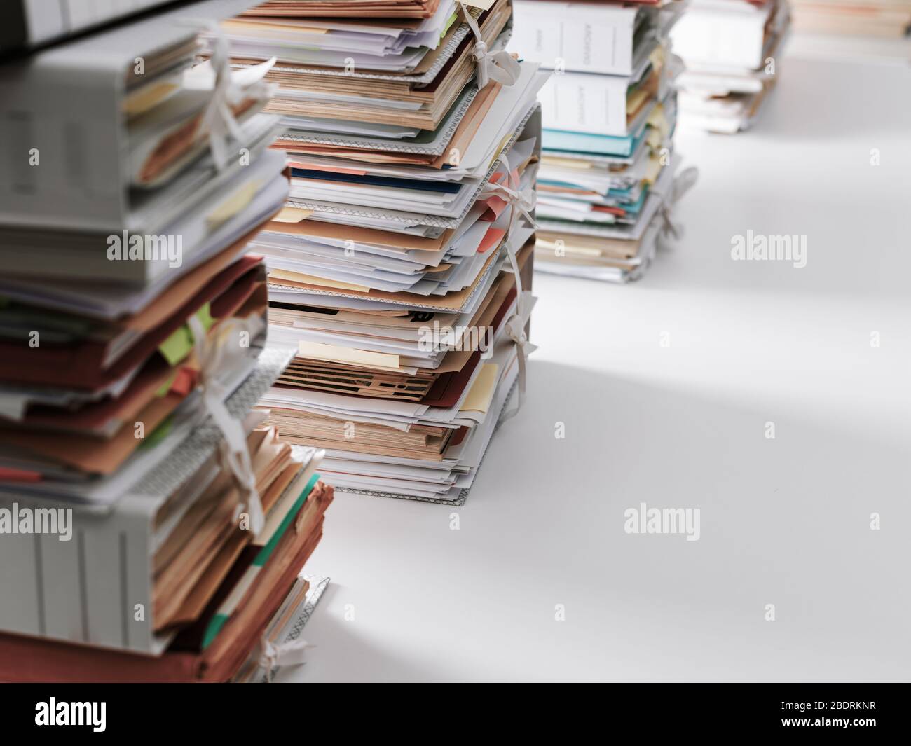 Stacks of paperwork and files in the office: work overload, files ...