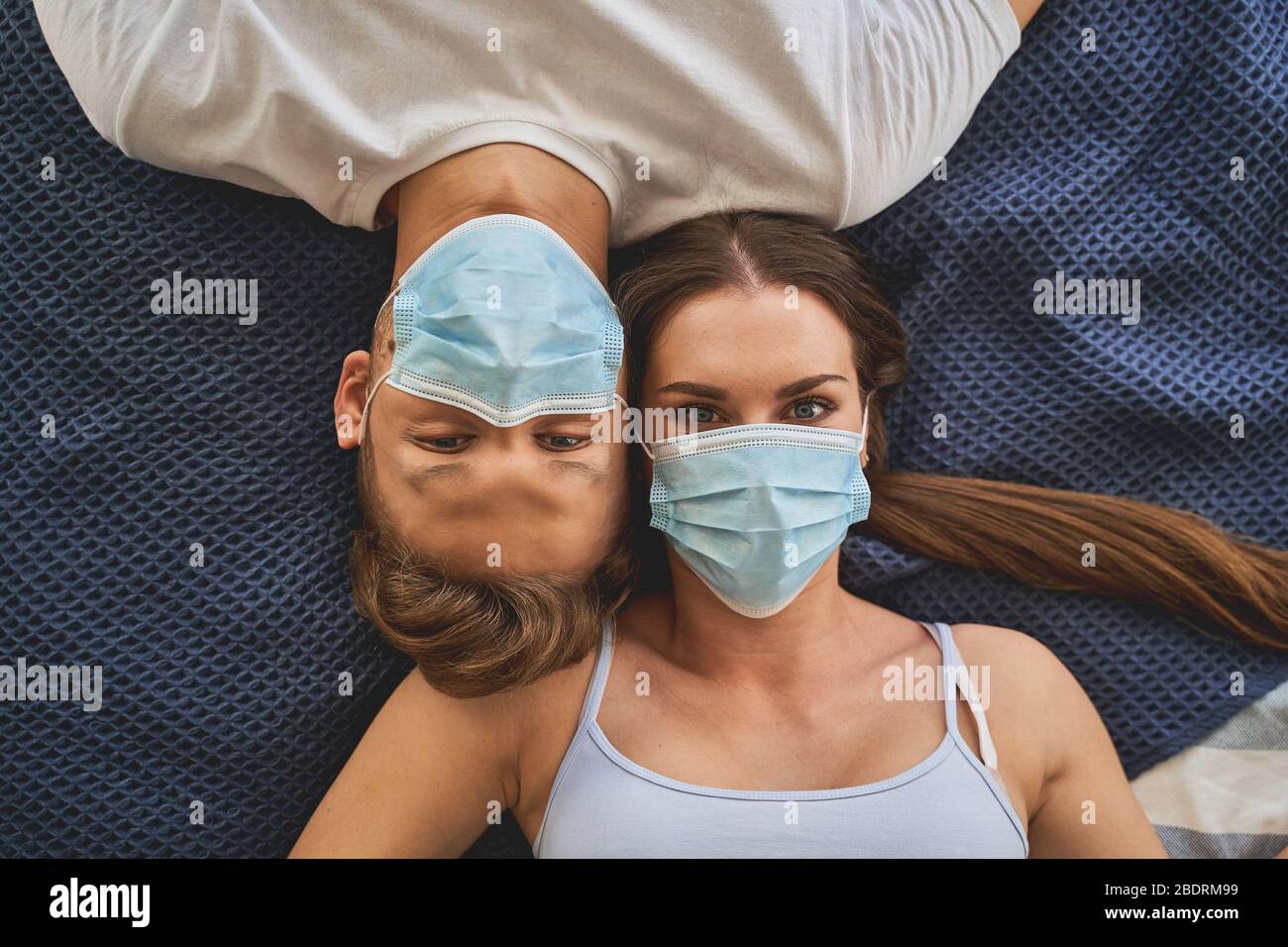 Top view of young people that lying on bed Stock Photo - Alamy