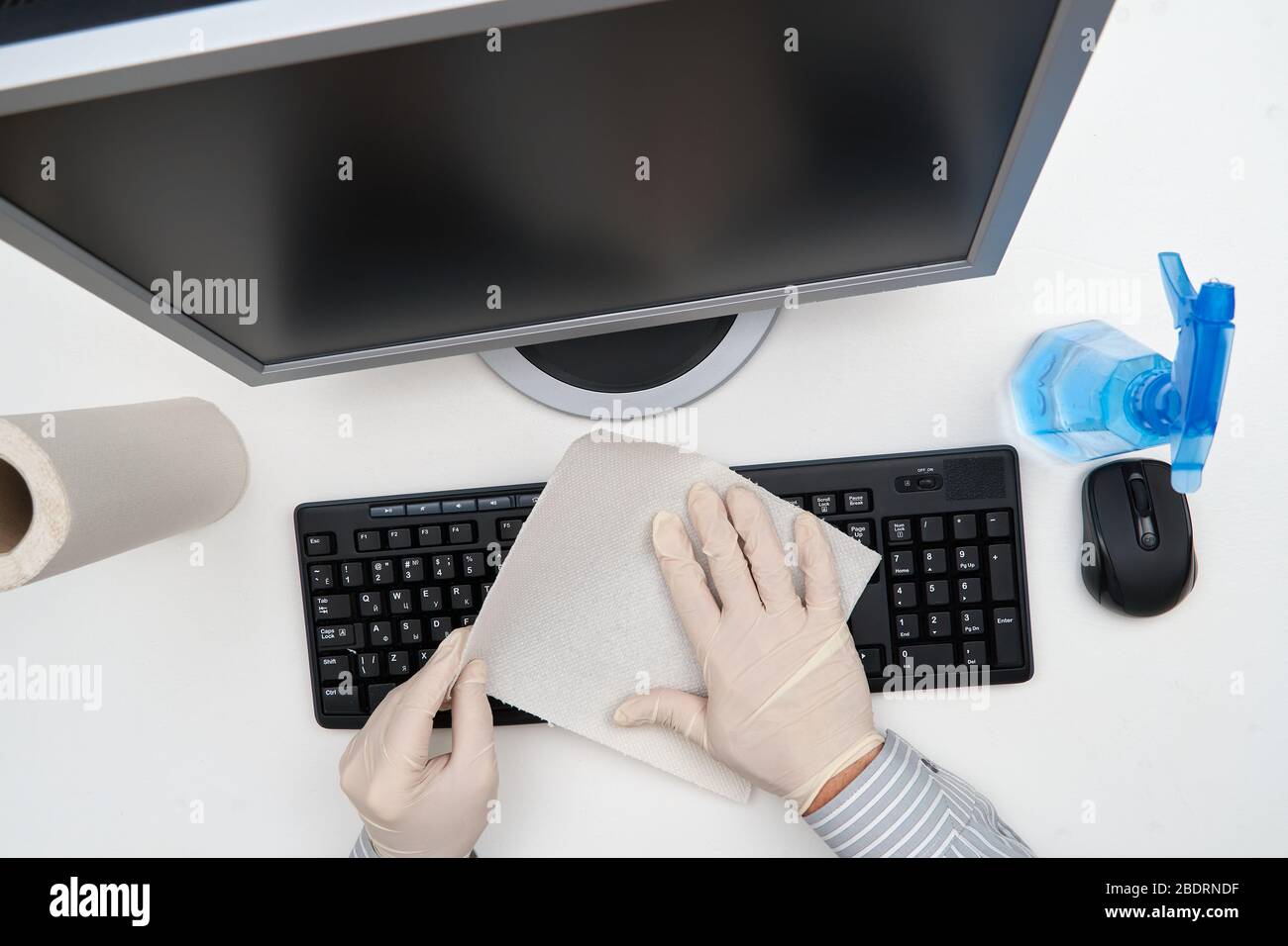 concept of cleaning or disinfecting the office - a businessman cleans ...