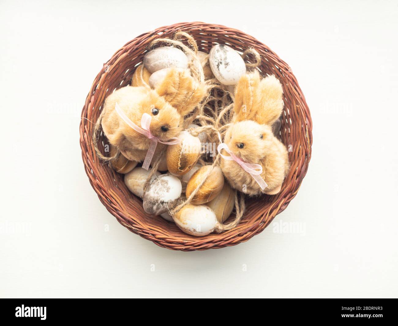 Easter greeting card with fluffy bunny and easter eggs in nest on white ...