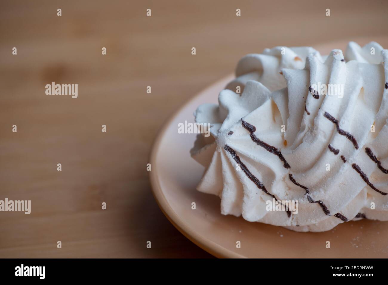 Light textured white meringue shells dot surface. Meringue cake Stock ...