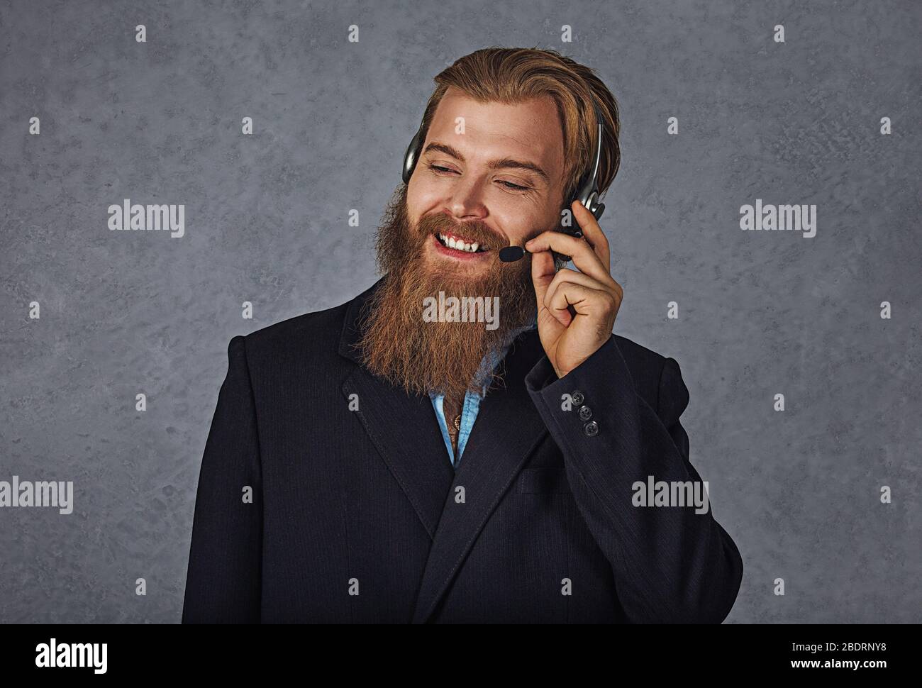 Male operator. Handsome young man portrait in formal wear and headset ...