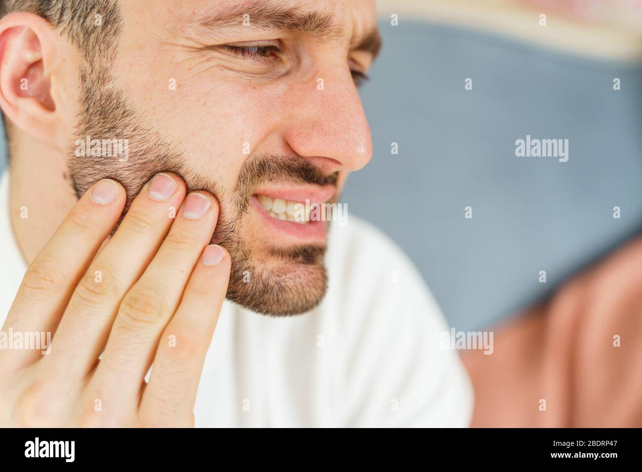 Sad male suffering from a severe toothache Stock Photo - Alamy