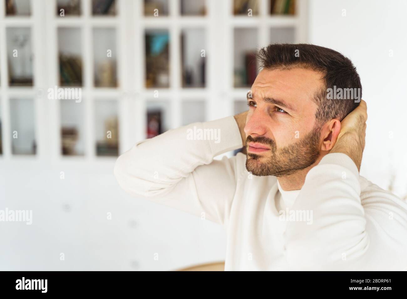 Upset young man staring into the distance Stock Photo - Alamy