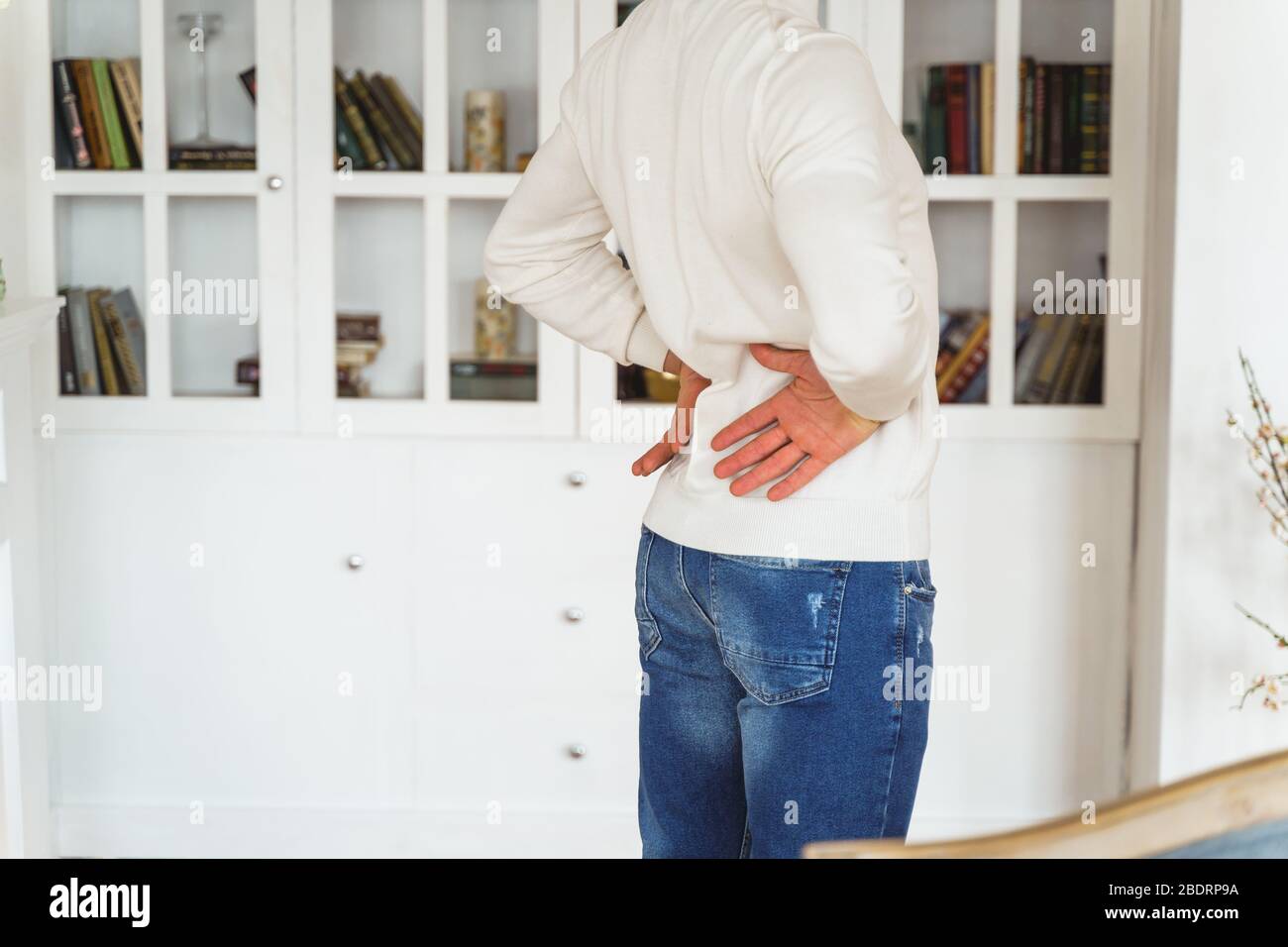 Office worker experiencing a lower back pain Stock Photo - Alamy