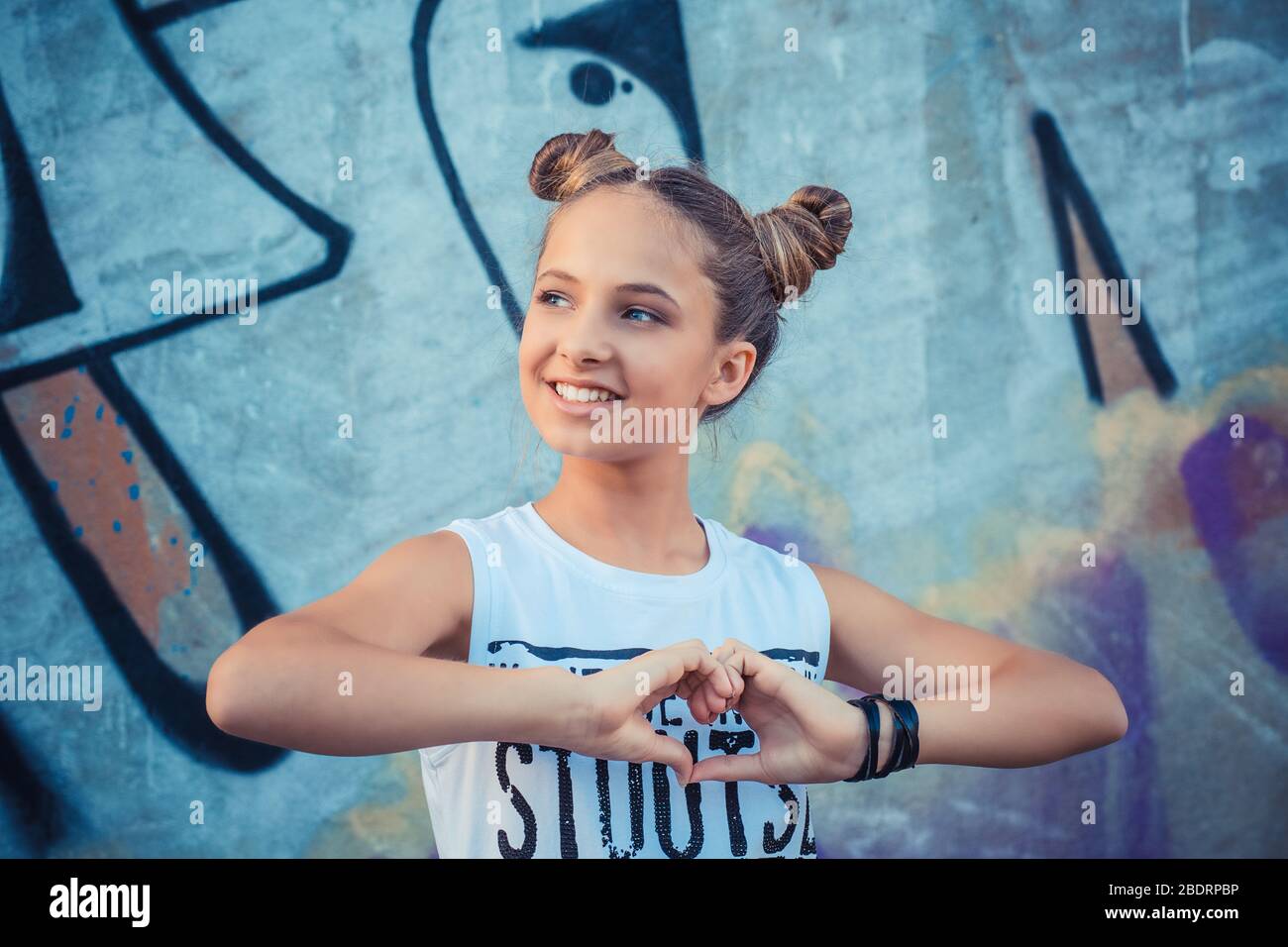 Closeup portrait smiling cheerful happy girl making heart sign with ...