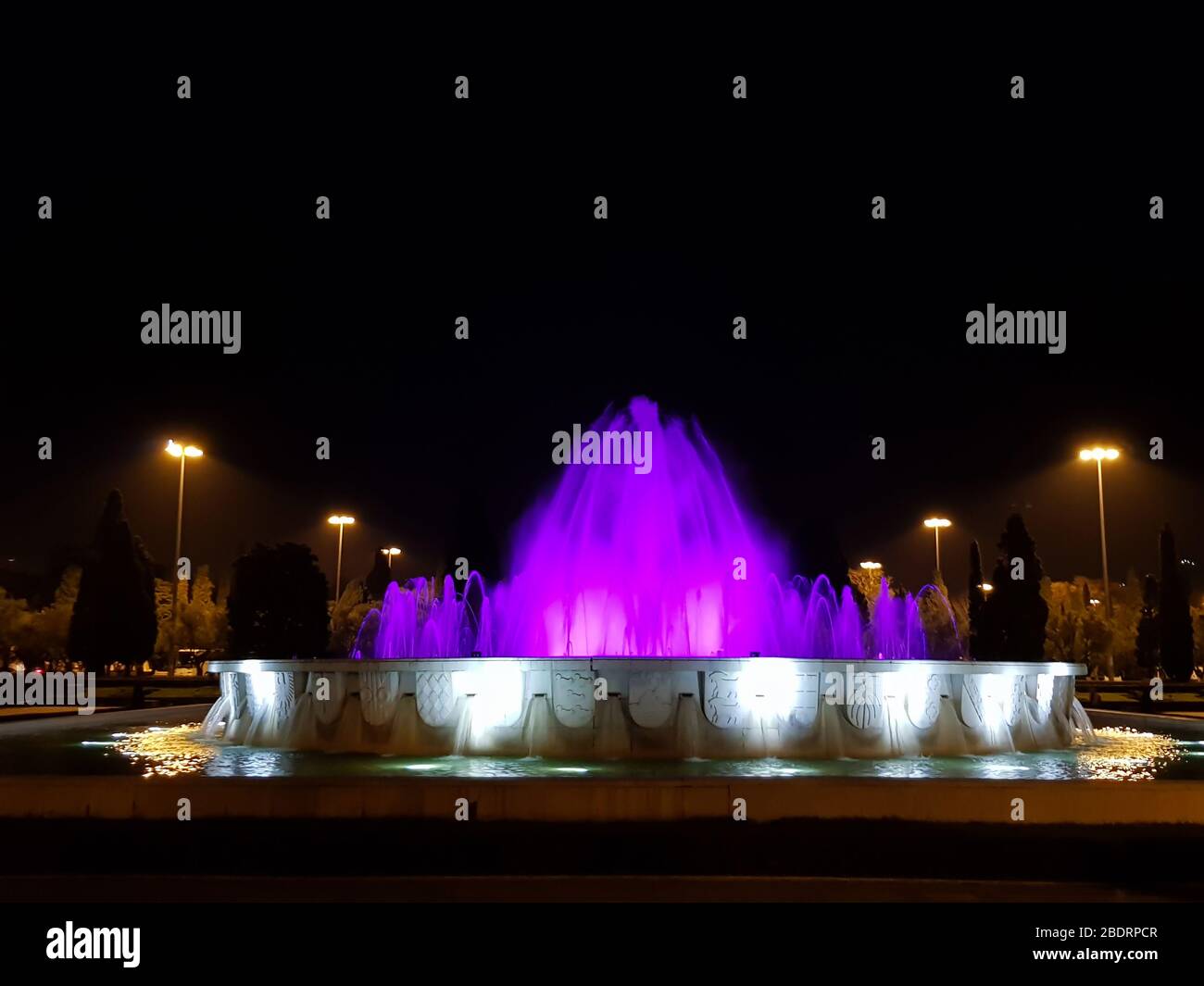 Water fountain with colored water at night Stock Photo - Alamy
