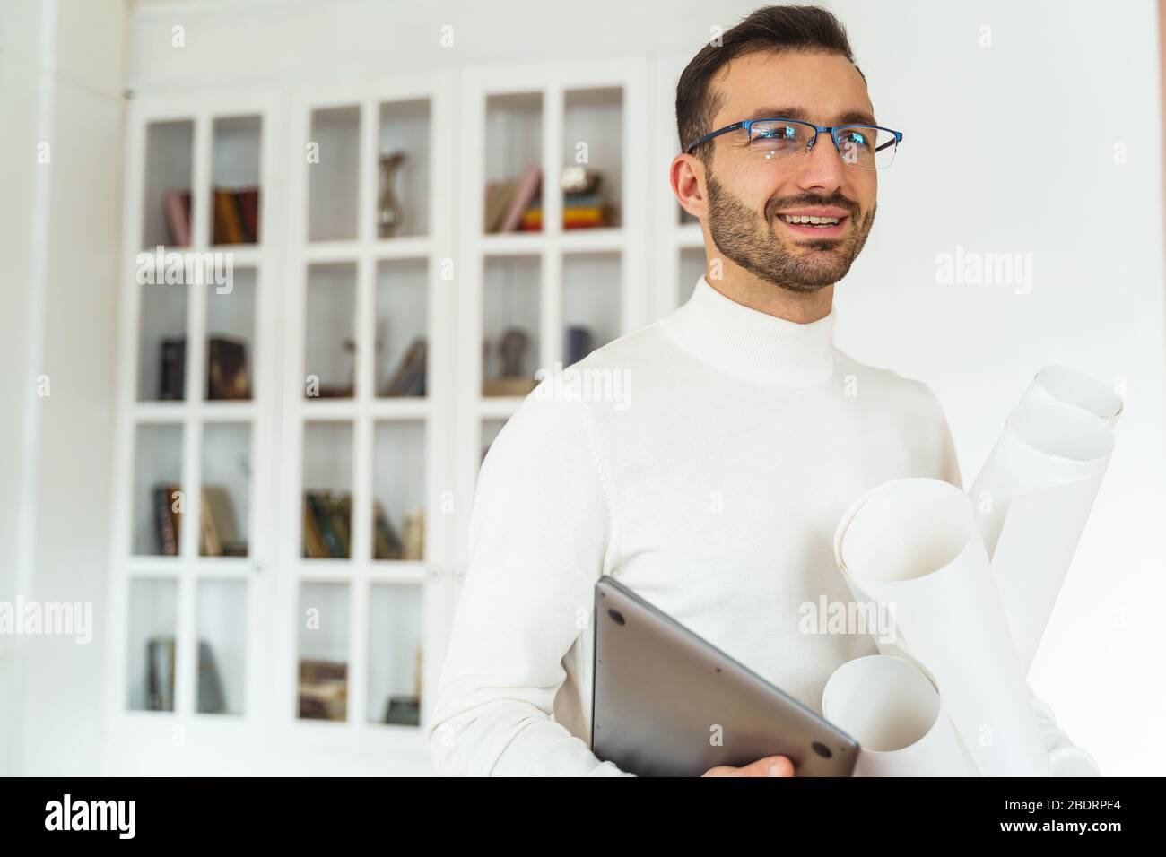 High-spirited young man standing in the office Stock Photo - Alamy