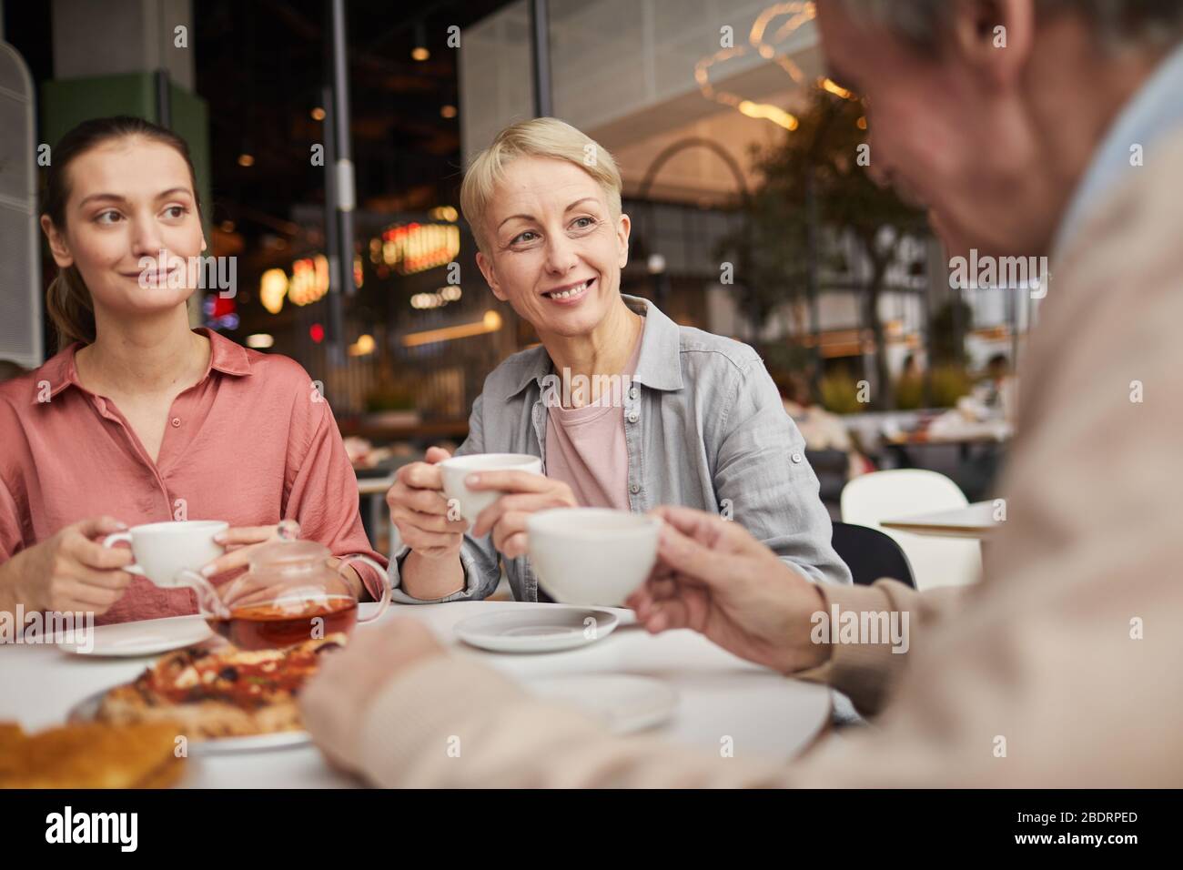 Family enjoying tea in cafe hi-res stock photography and images - Alamy