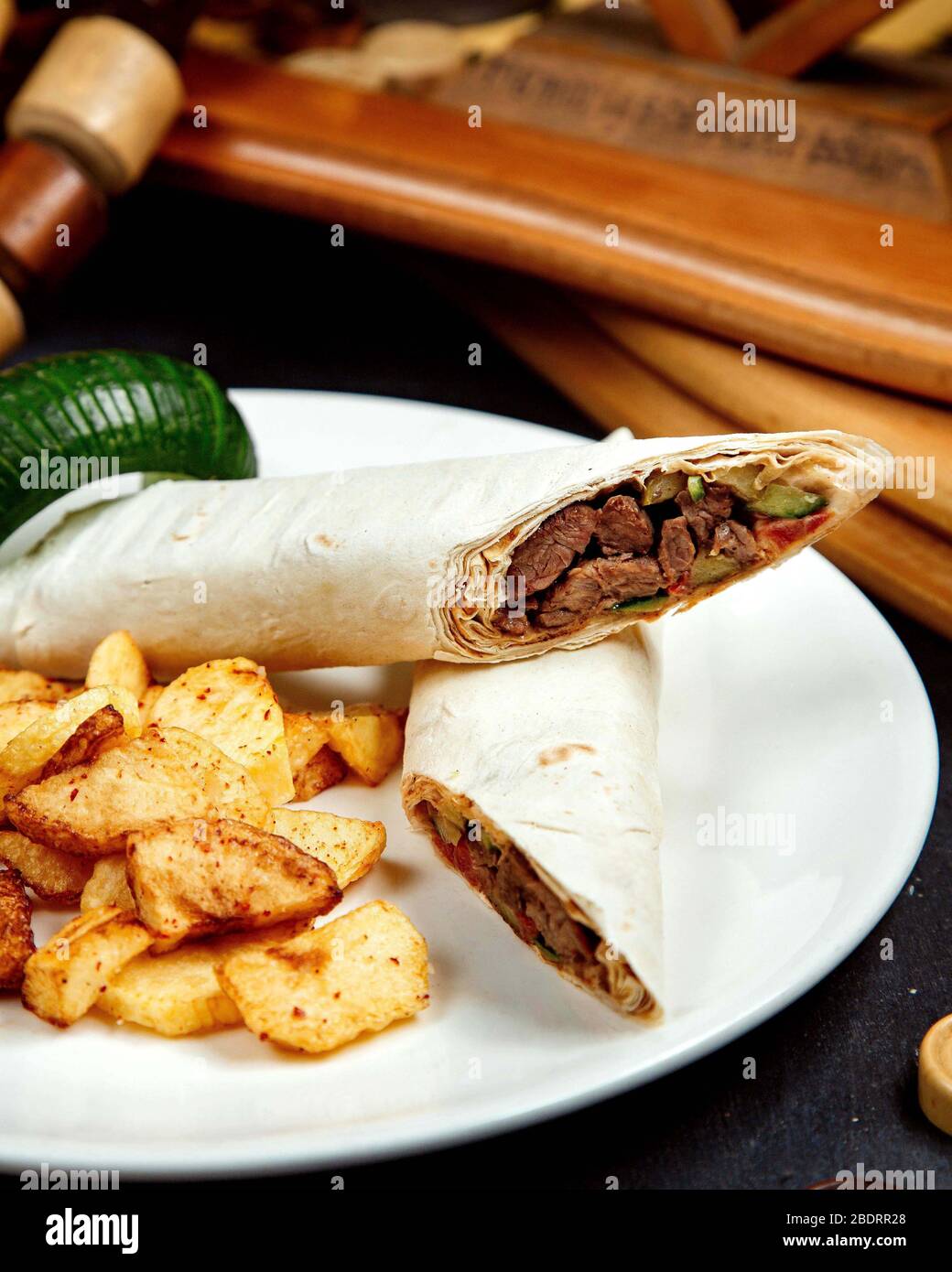 beef doner wrap in flatbread served with fried potato Stock Photo - Alamy