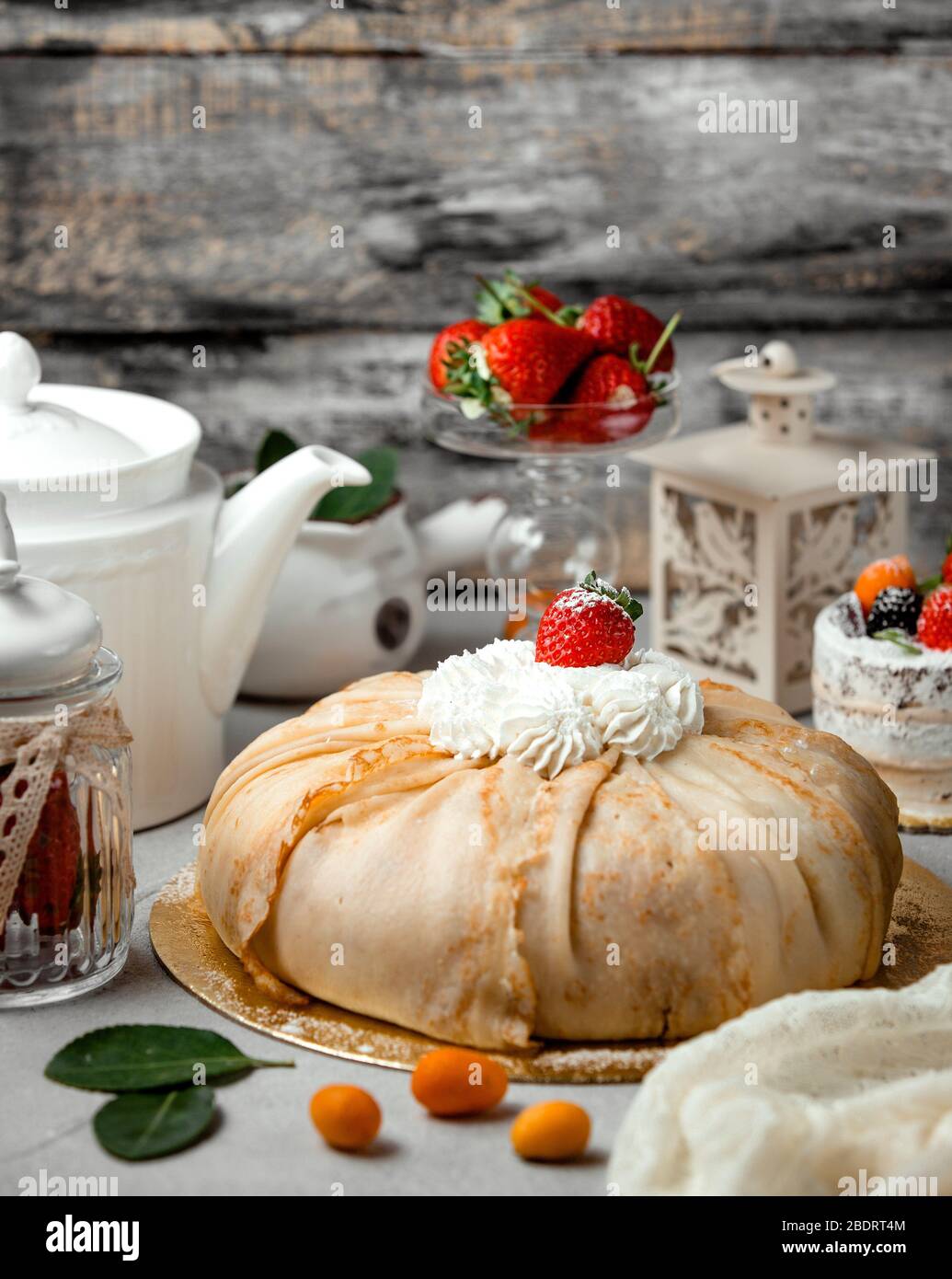crepe cake in bundle shape topped with cream and strawberry Stock Photo ...