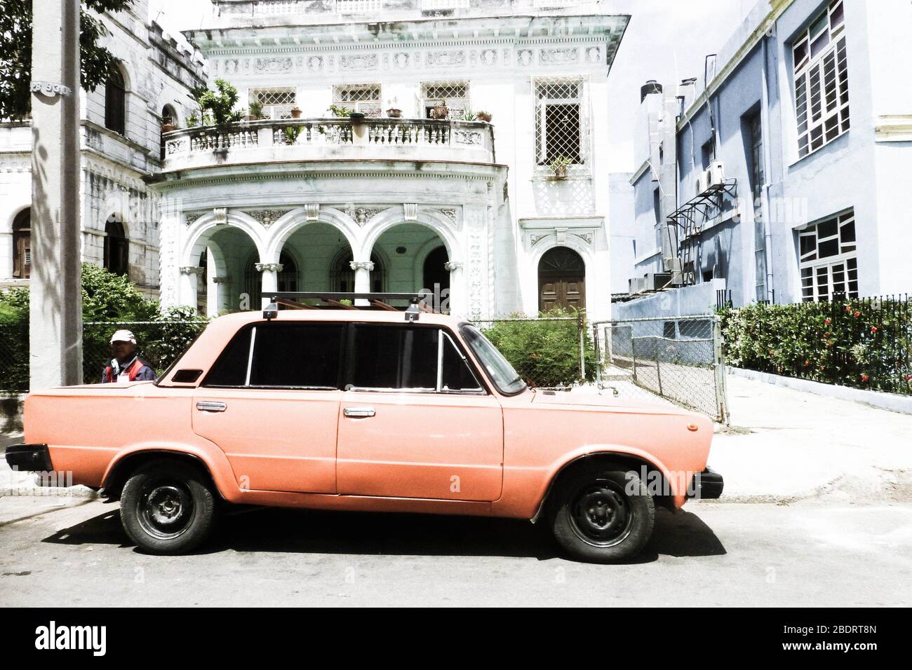 old Fiat 124 Italian red car in Havana Cuba in block of flats with ...