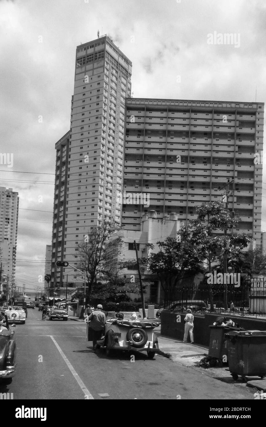Classic American car and flats in Havana Cuba street visit people ...