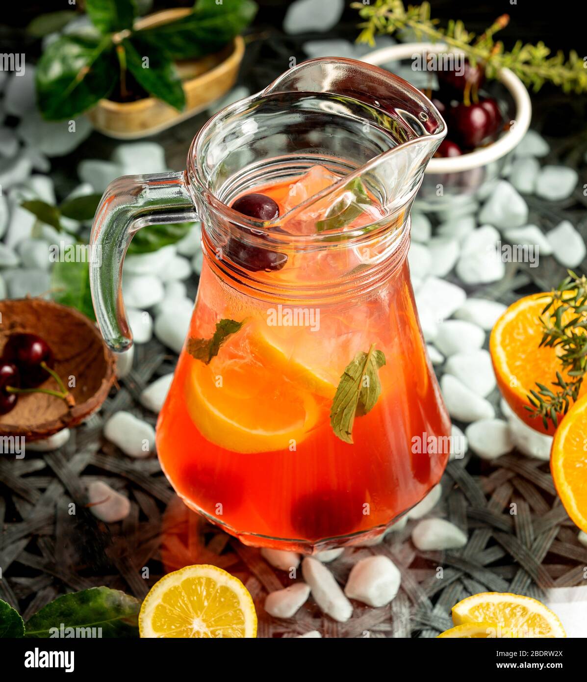 juice jug with orange cherry and mint Stock Photo - Alamy