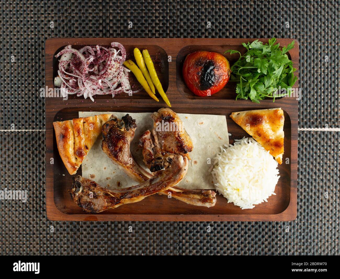 lamb rib kebab served with rice onion smoked vegetables and bread Stock ...