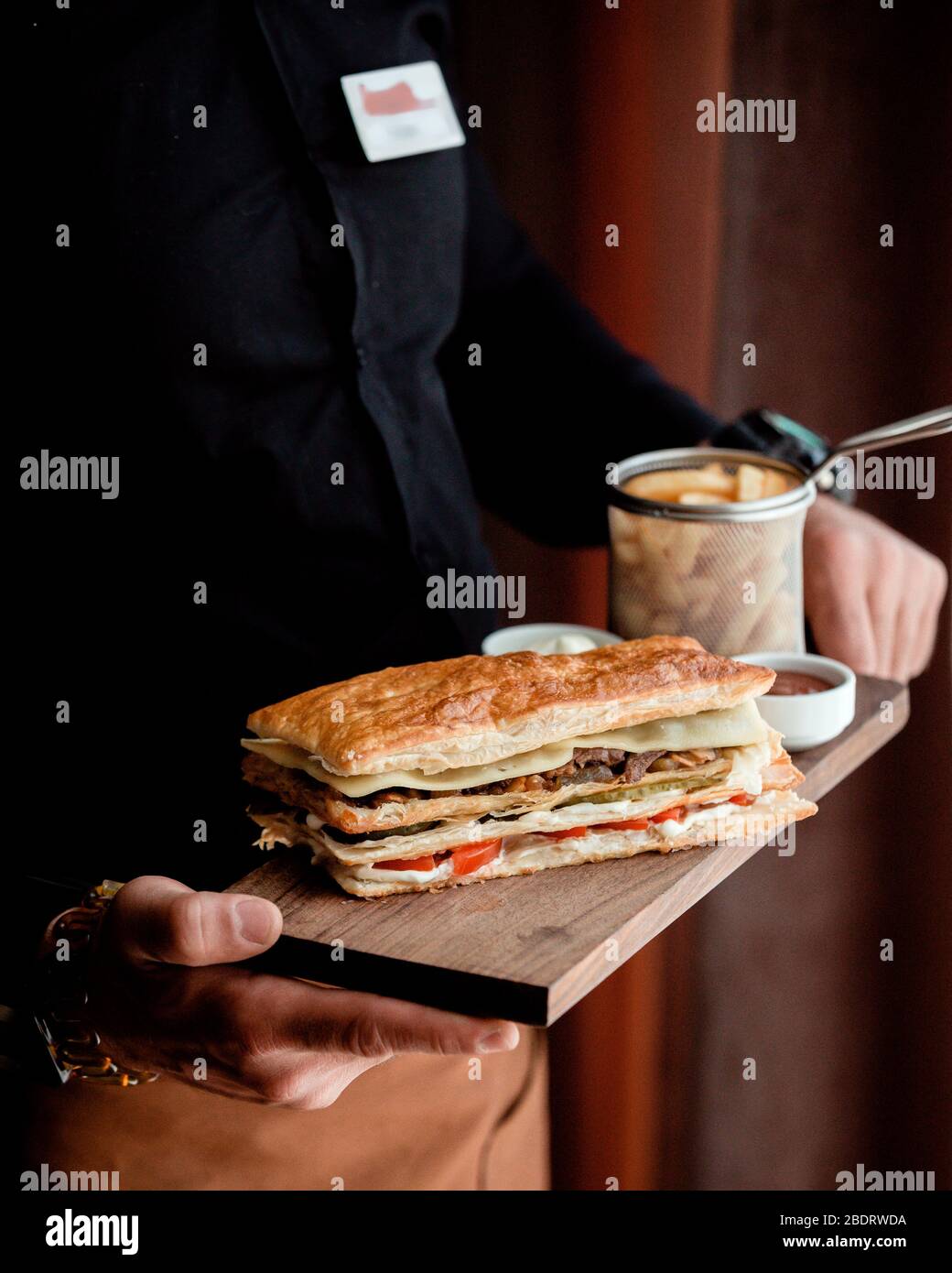 layered sandwich with puff pastry served with french fries and sauce ...