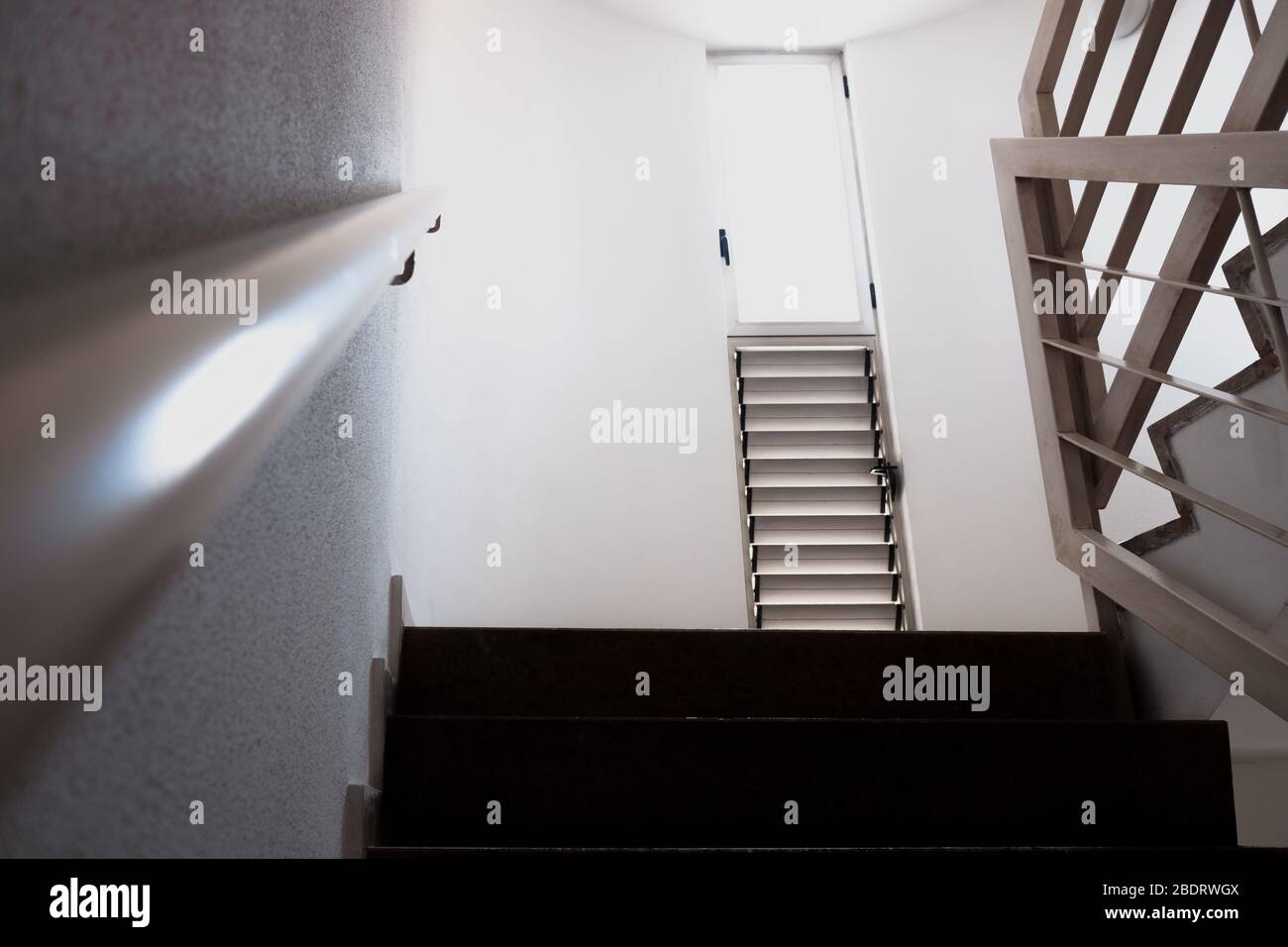 Community stairs of a building illuminated by a bright white light with ...