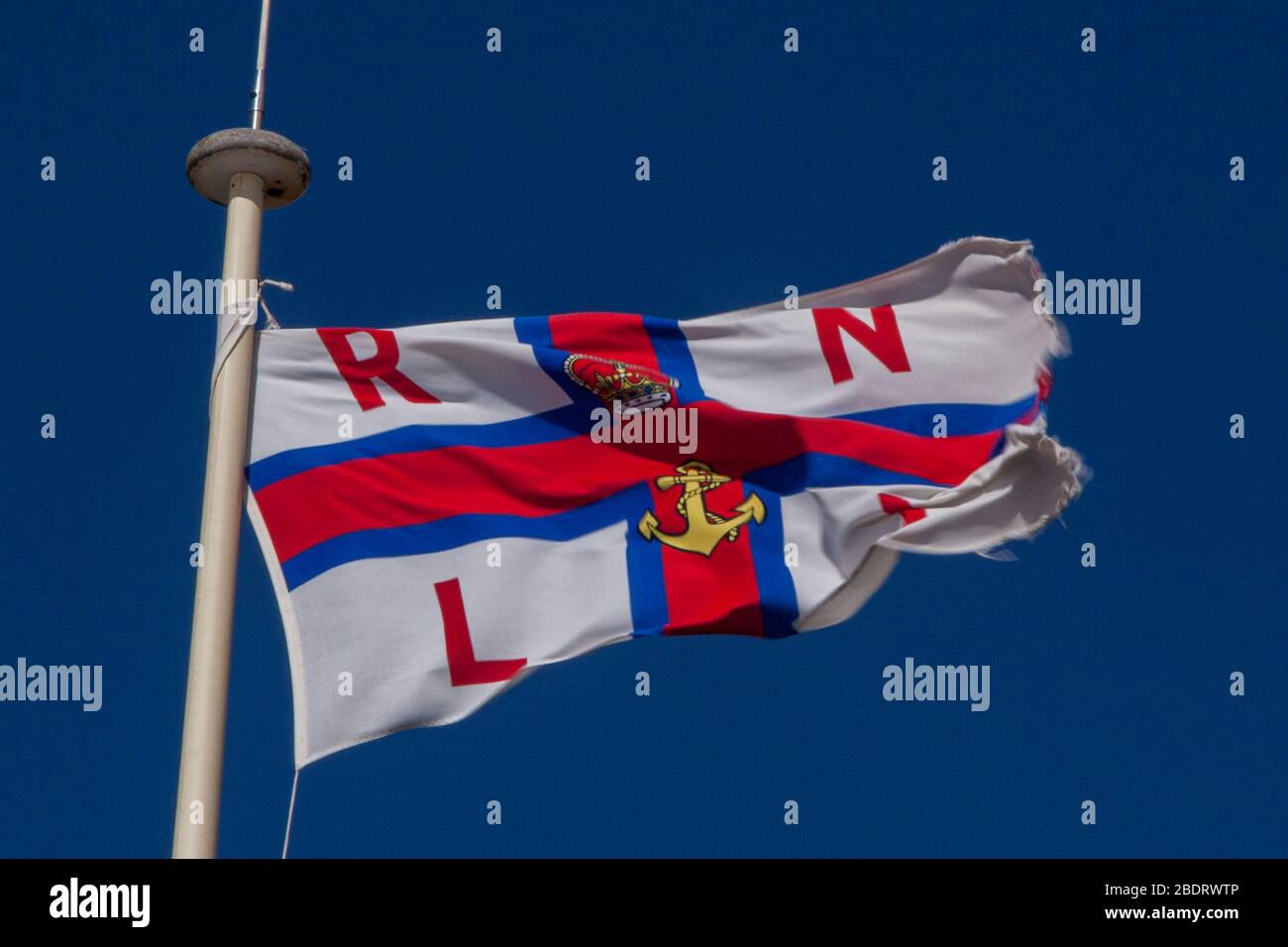 RNLI Lifeguard flag in flight at Porthcawl Town Beach. Lewis Mitchell ...