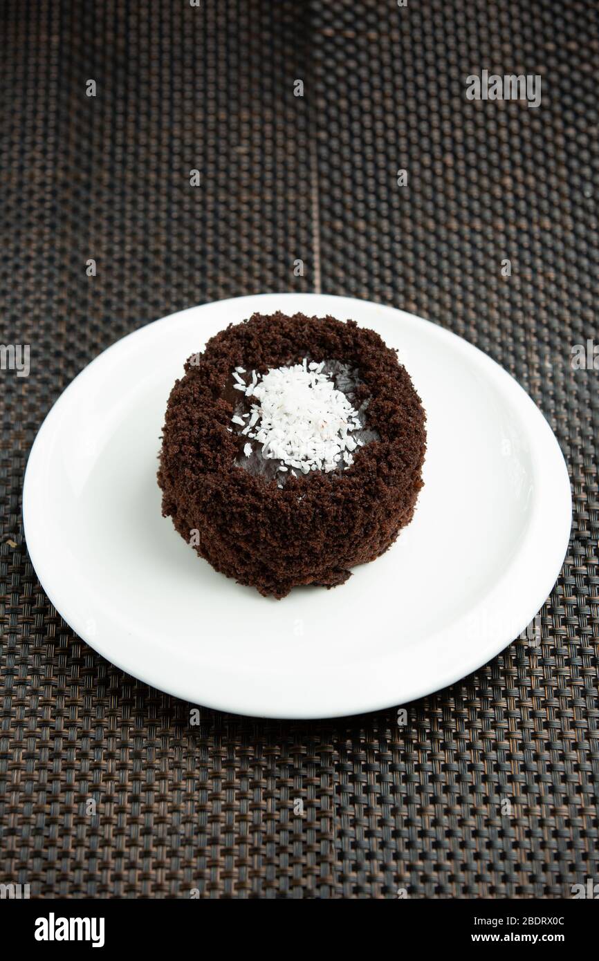 portioned chocolate cake with coconut sprinkles Stock Photo - Alamy
