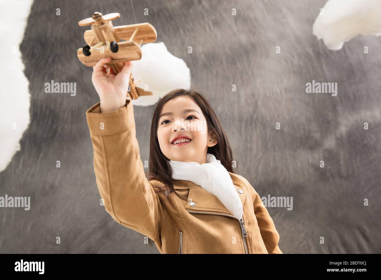 Happy girl with a model plane Stock Photo - Alamy