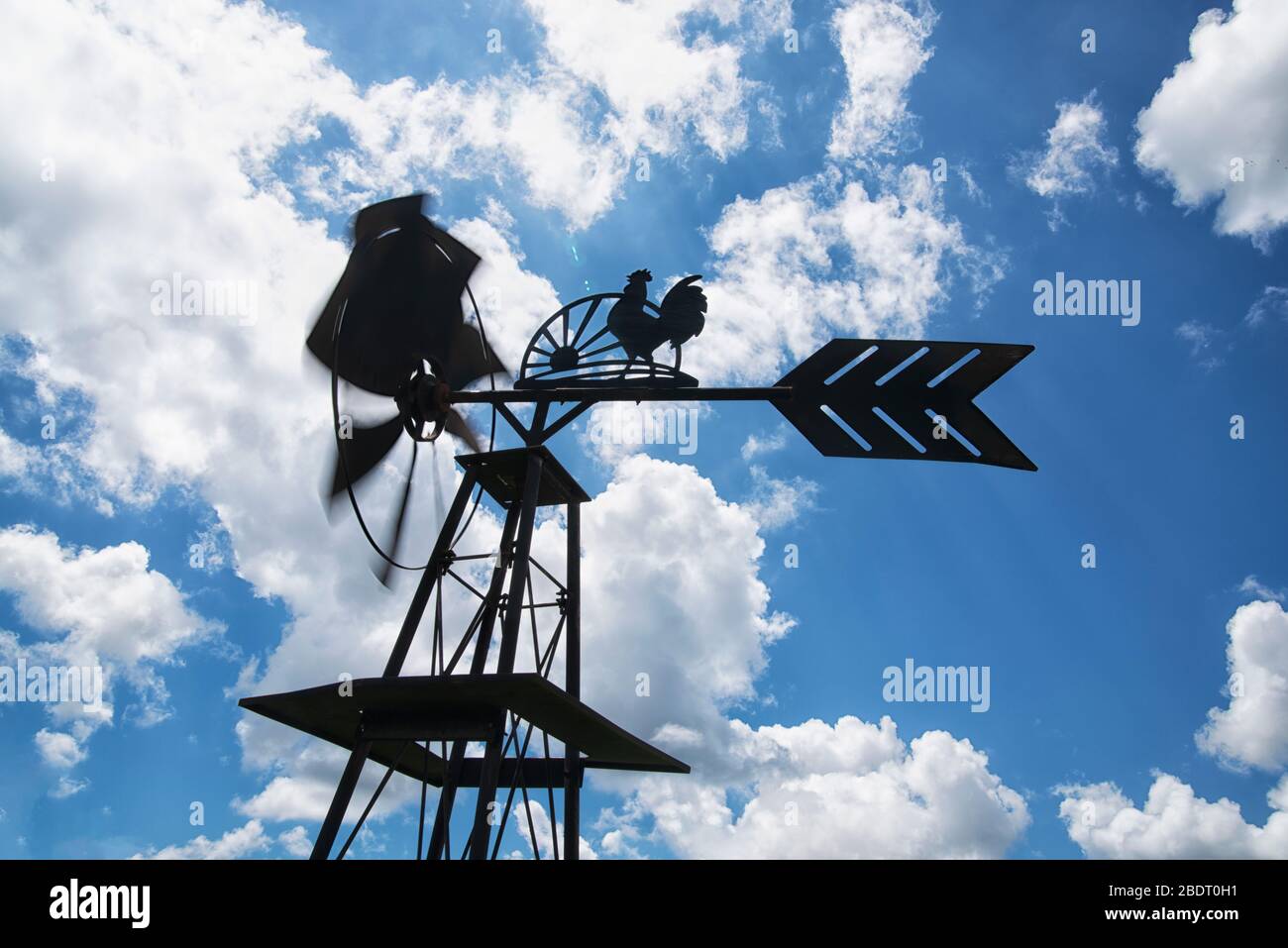 decorative yard windmill showing movement against a beautiful blue sky ...