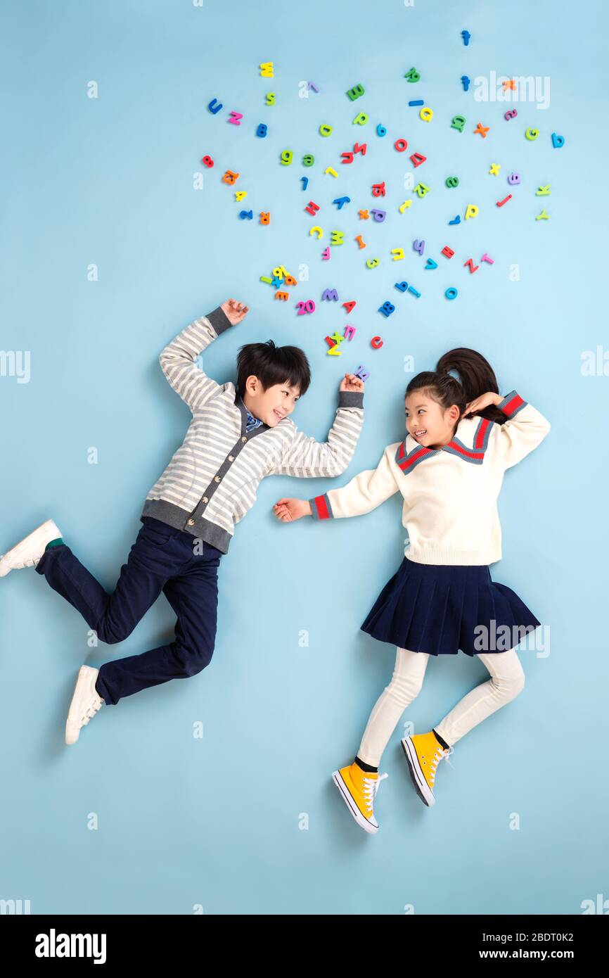 Happy children learn alphanumeric character Stock Photo - Alamy