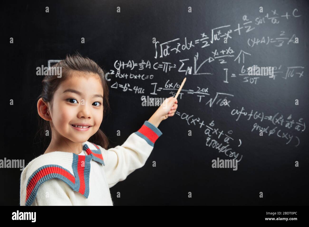 The little girl pointed to the math problem on the blackboard Stock ...
