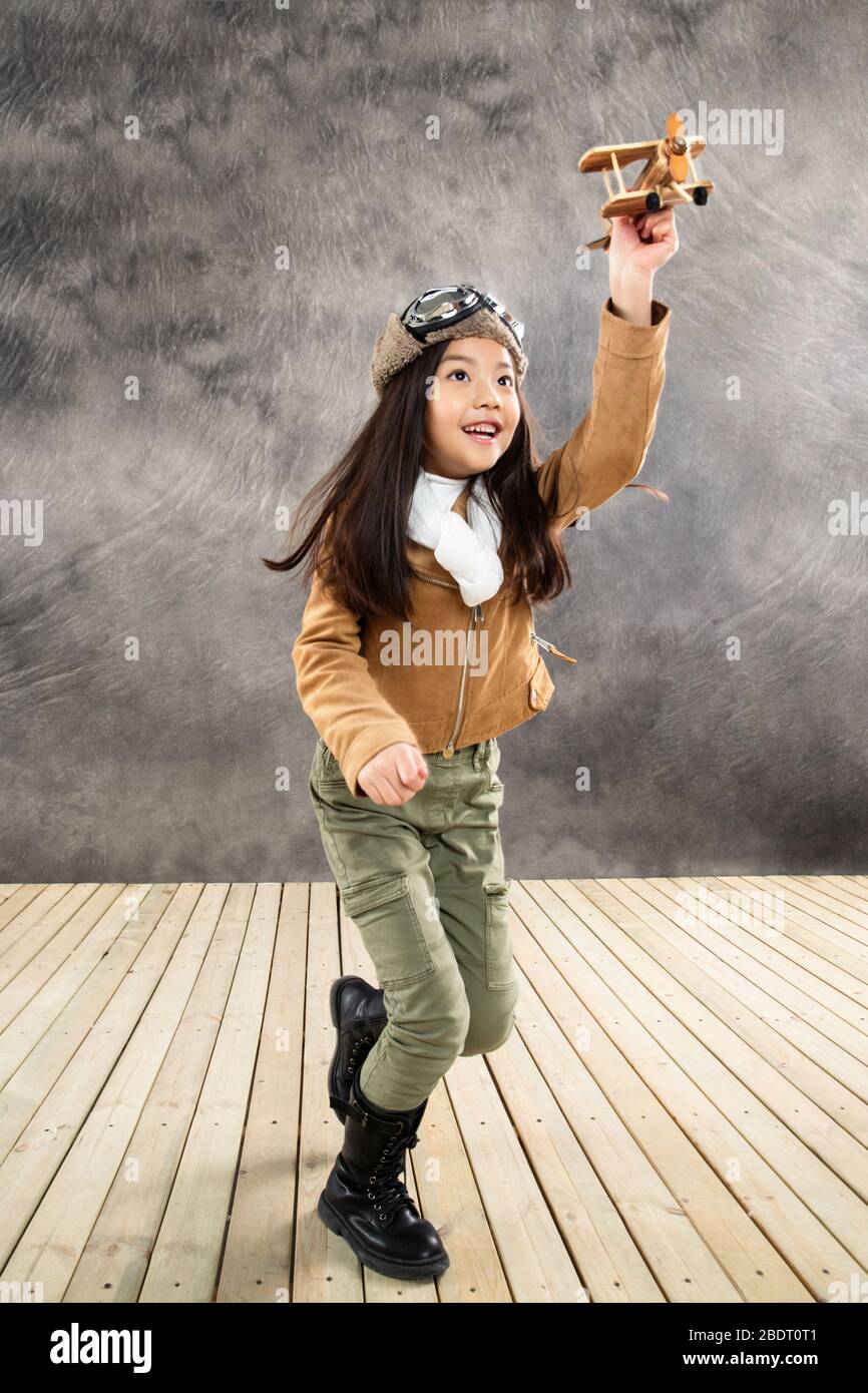 The girl with a model plane running Stock Photo - Alamy