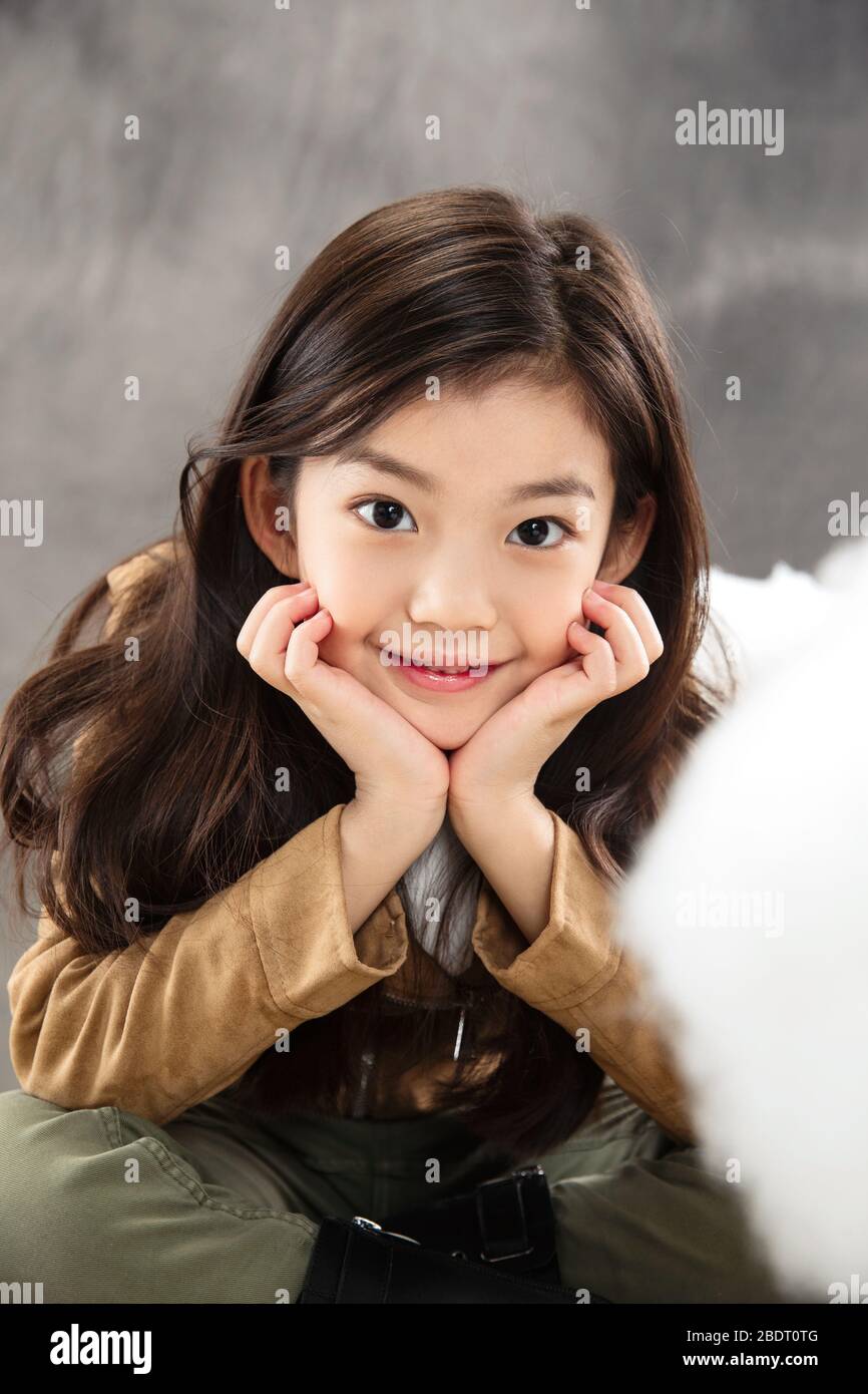 Holding a face of confidence girl Stock Photo - Alamy