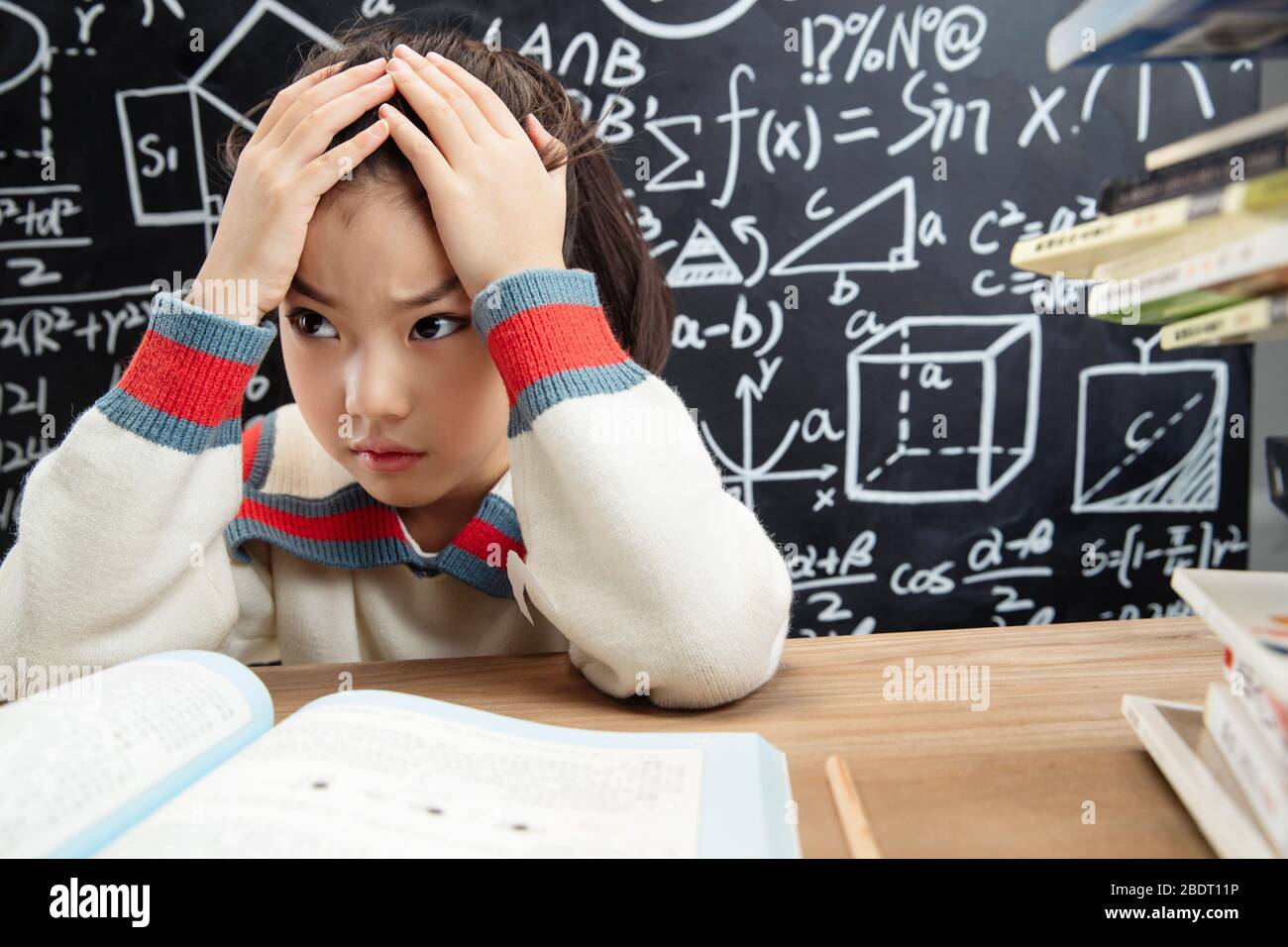 Learning to learn collapse of the little girl Stock Photo - Alamy