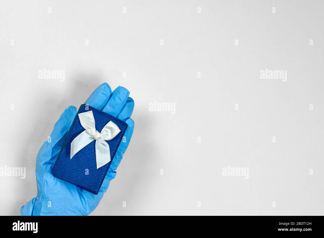 Celebration holiday, birthday in hospital. Doctor giving giftbox to ...