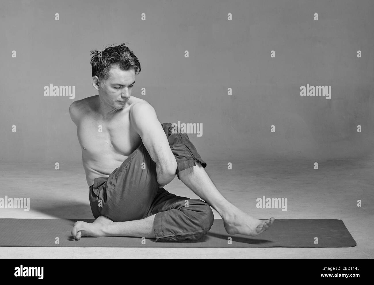 Young handsome man performing yoga exercises Stock Photo - Alamy