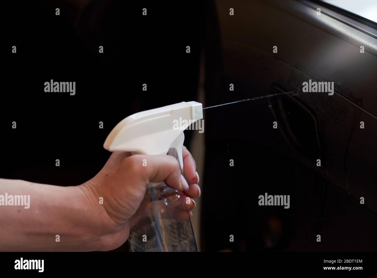Car disinfecting service. Woman disinfecting and cleaning the inside ...