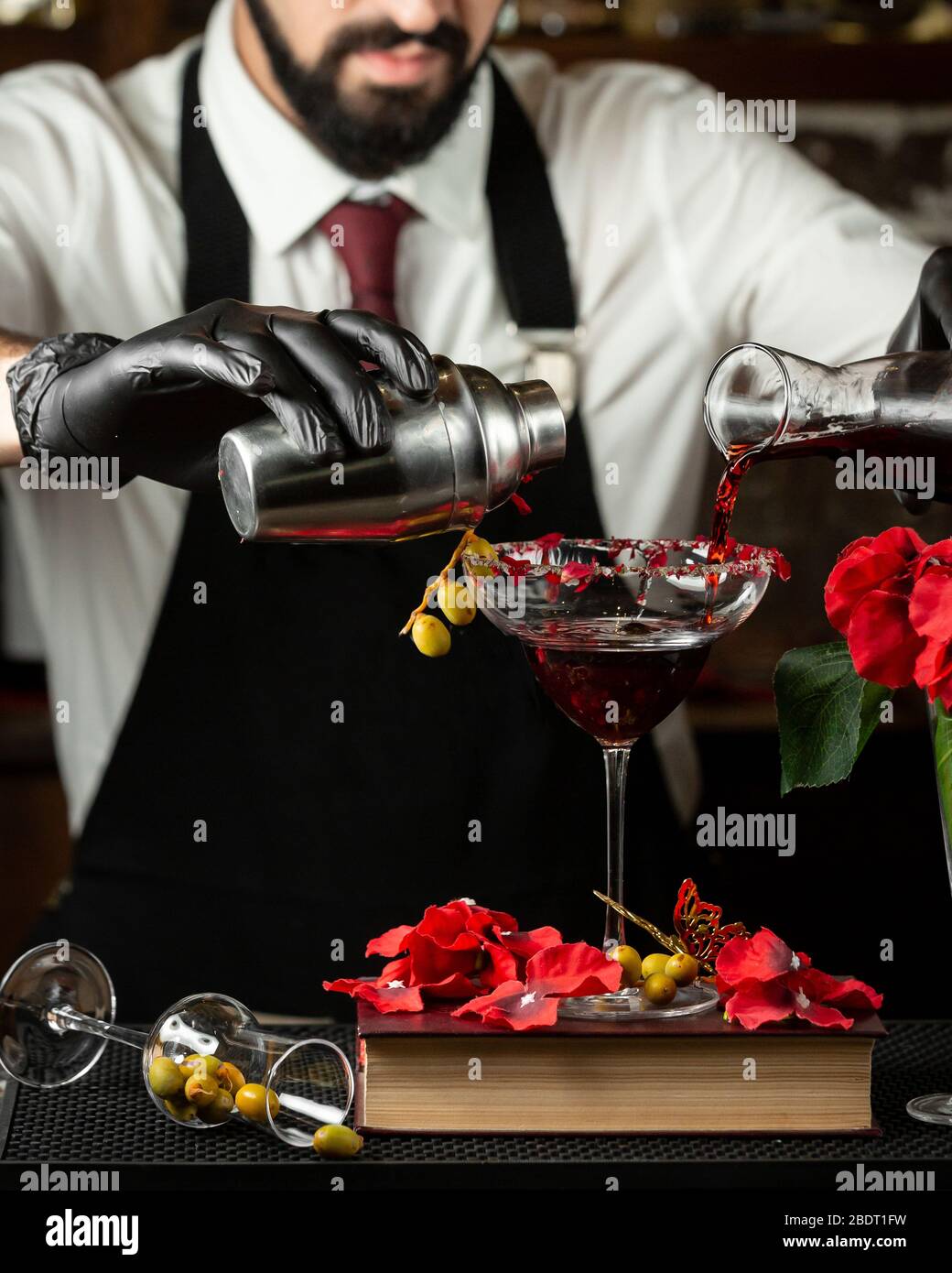 bartender pours cocktail mix into a glass Stock Photo - Alamy