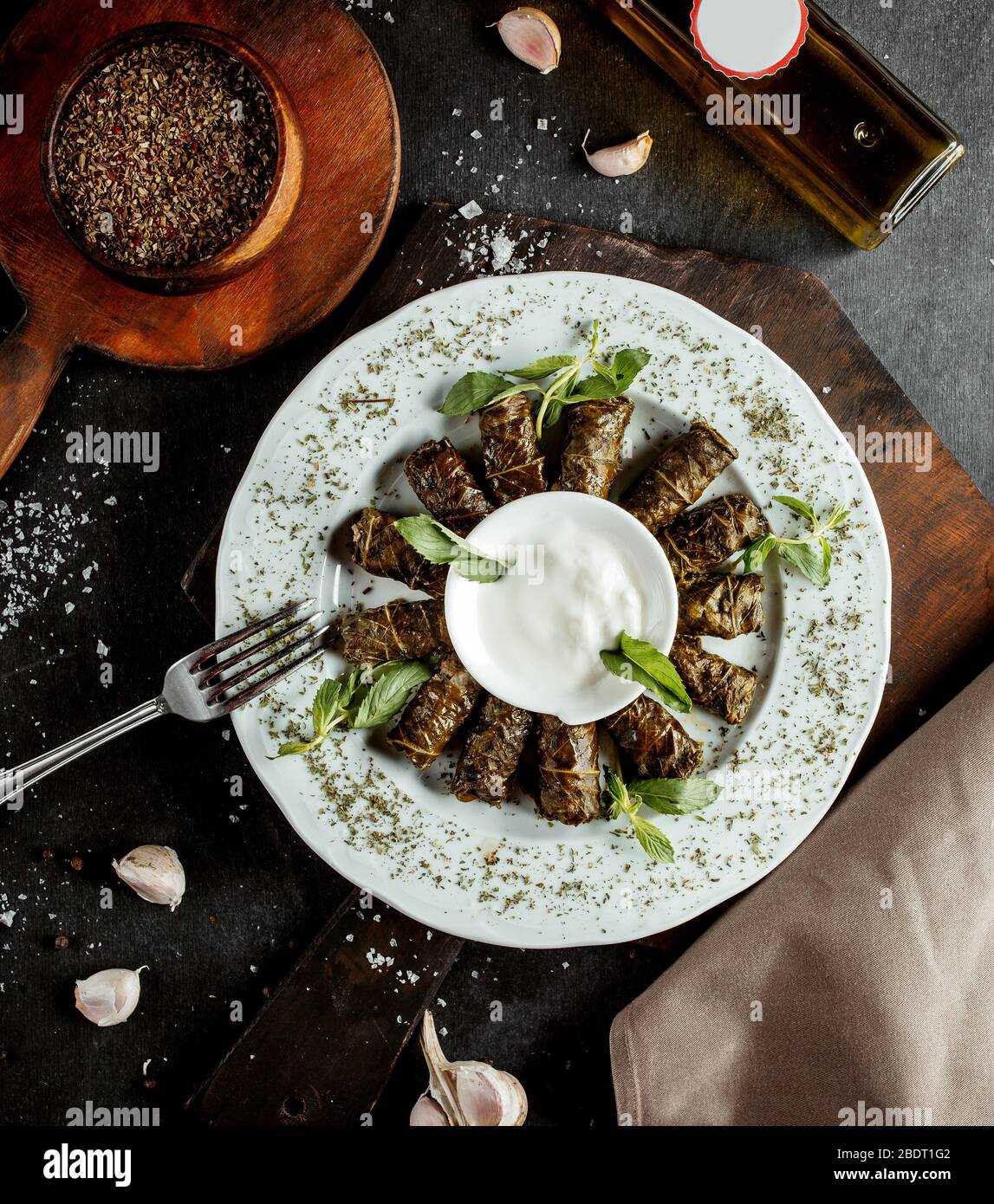 azerbaijani long wrapped grape leaves dolma garnished with yogurt and ...