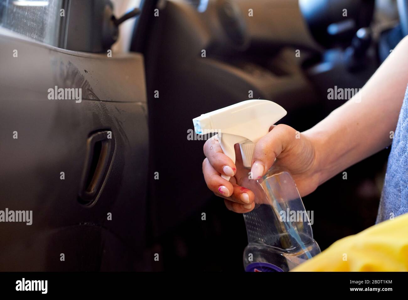Car disinfecting service. Woman disinfecting and cleaning the inside ...