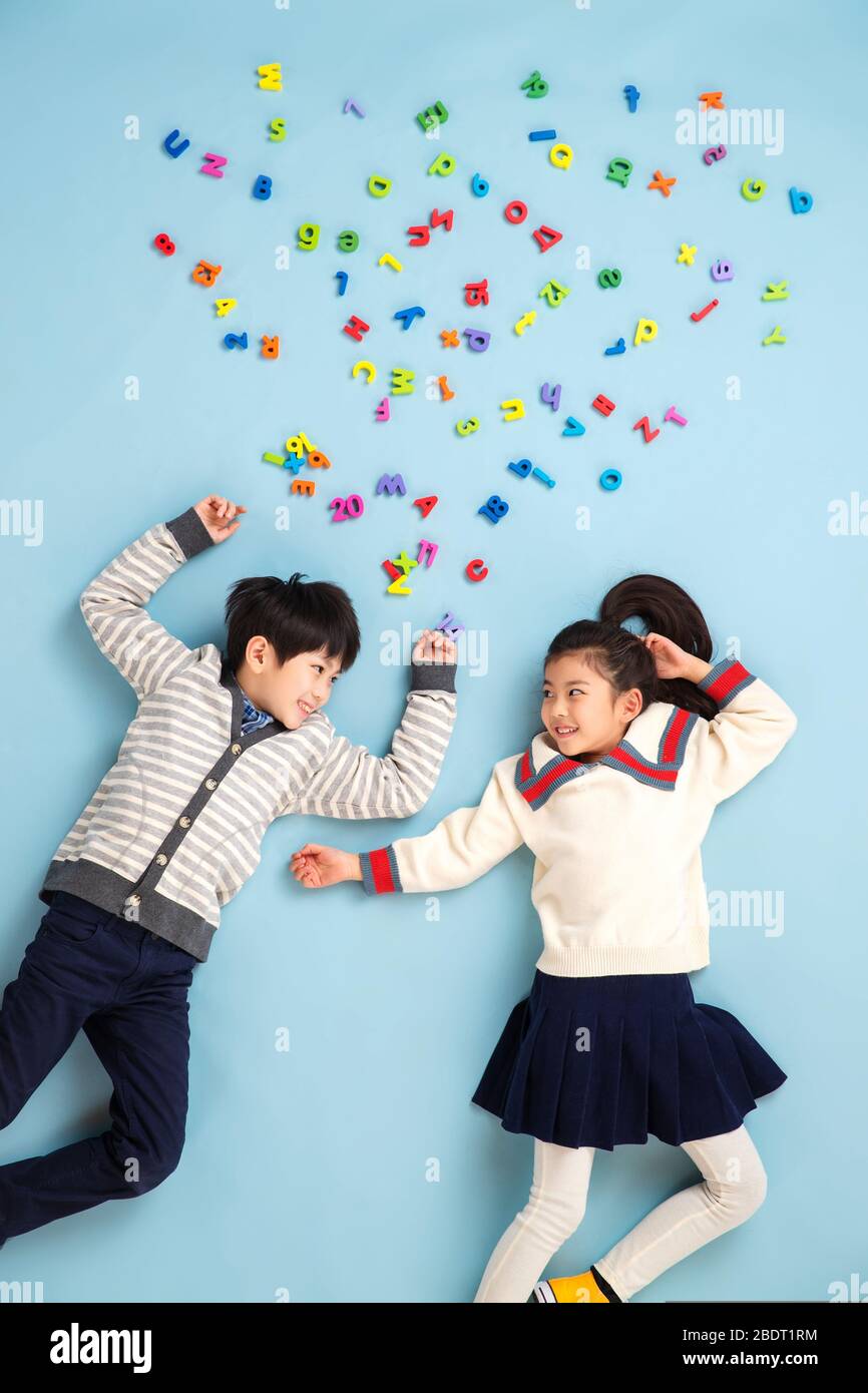 Happy children learn alphanumeric character Stock Photo - Alamy